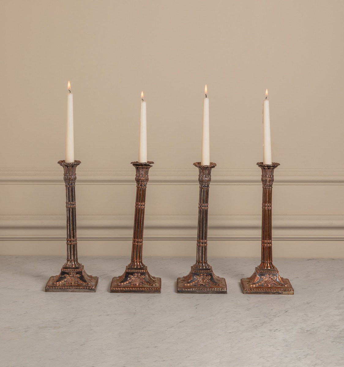 A set of four silver plated cluster column candlesticks, circa 1800 ...